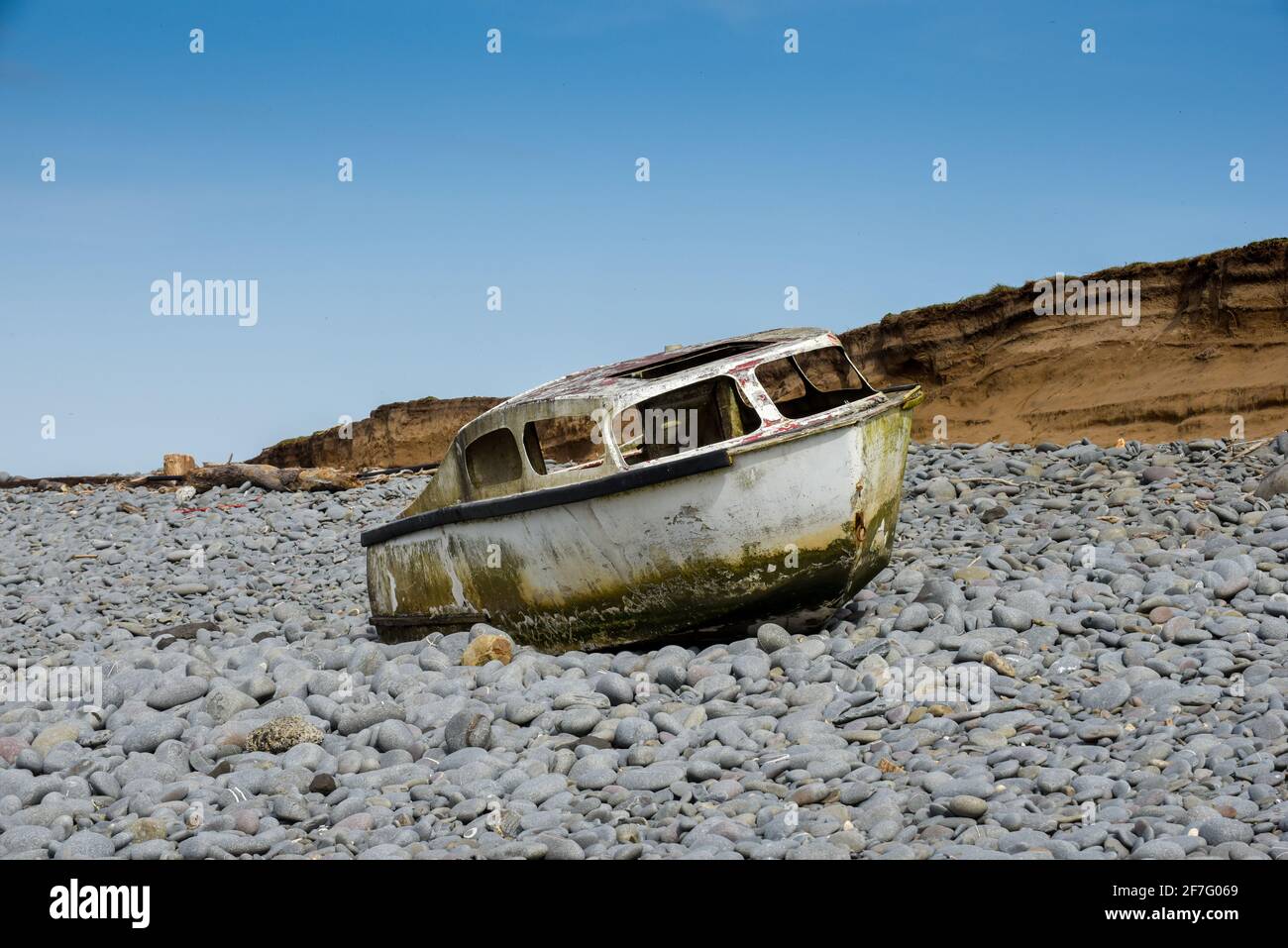 Ship wreck of an old boat washed up on a rocky beach Stock Photo - Alamy