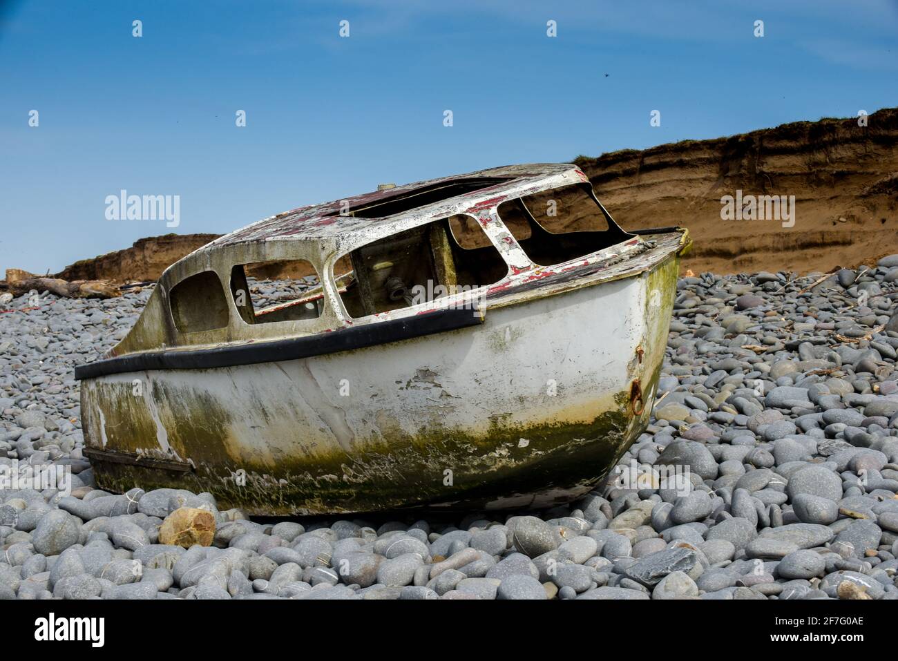 Ship wreck of an old boat washed up on a rocky beach Stock Photo - Alamy