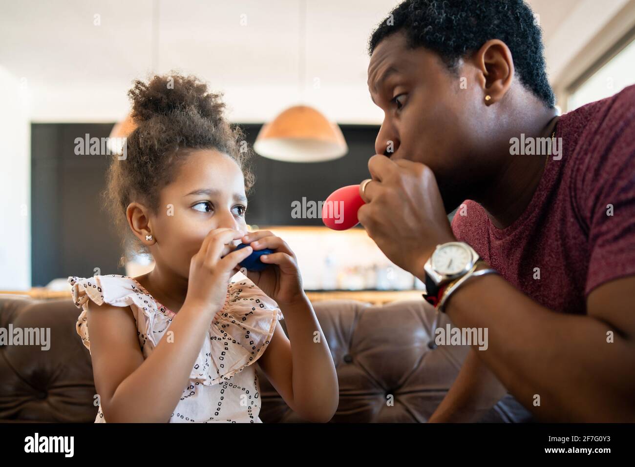 Daughter and father playing together at home Stock Photo - Alamy
