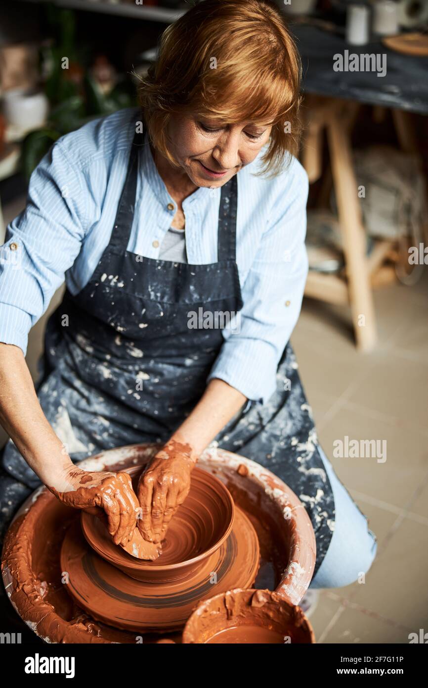 Lovely old woman making pottery in workshop Stock Photo - Alamy
