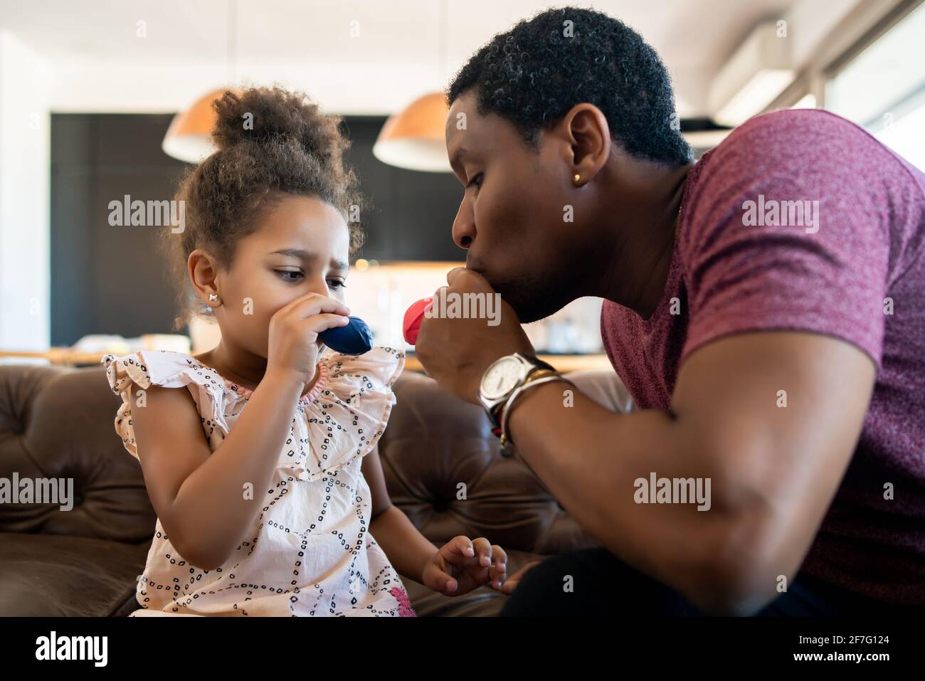 Daughter and father playing together at home Stock Photo - Alamy