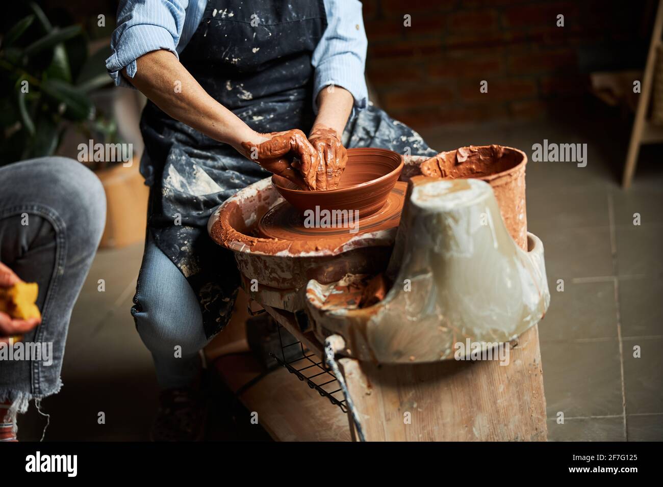 Female potter making clay pot hi-res stock photography and images - Alamy