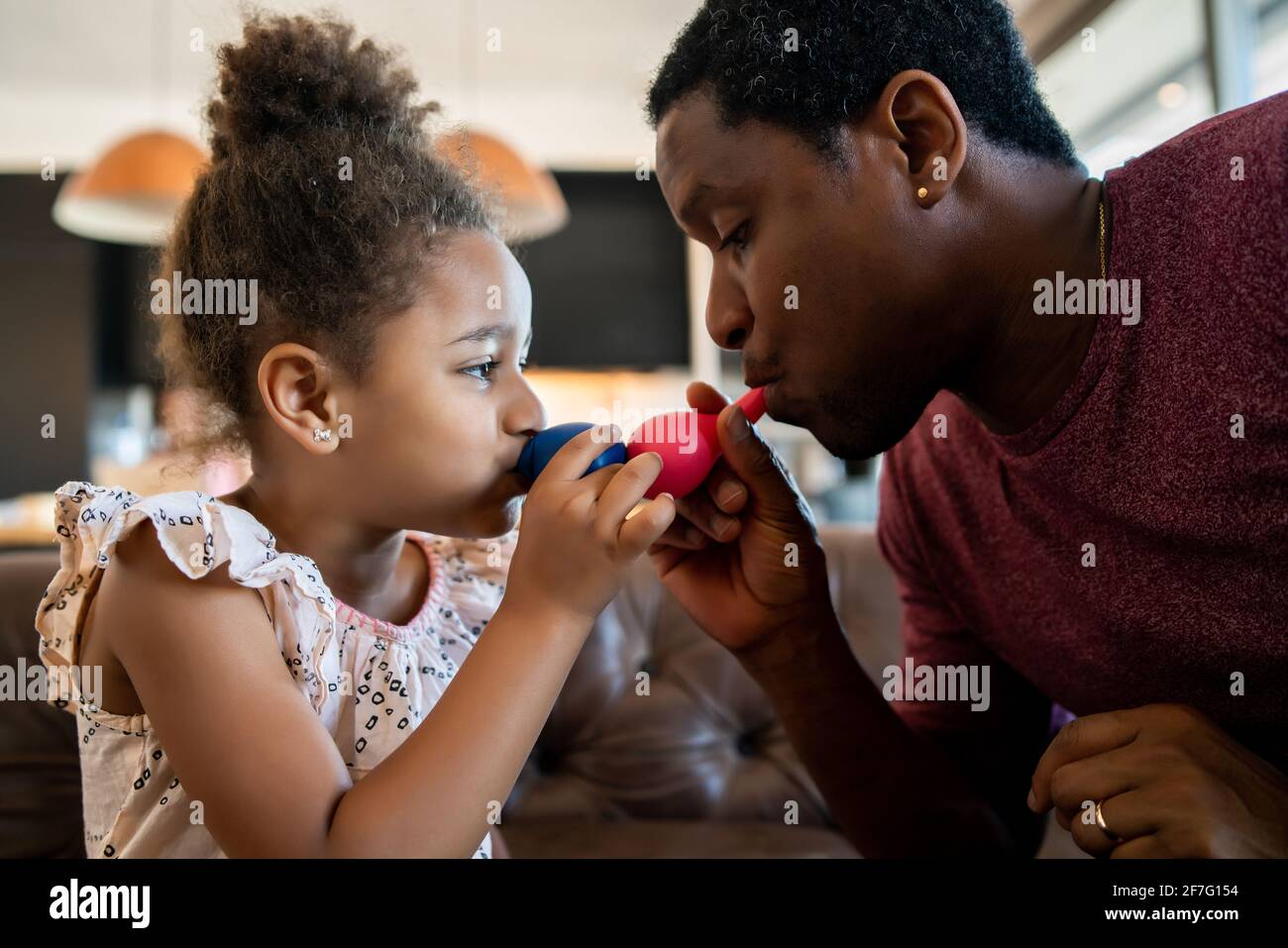 Daughter and father playing together at home Stock Photo - Alamy
