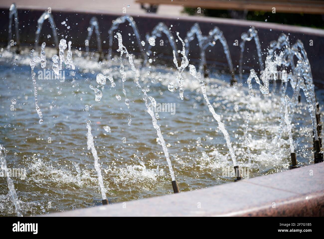 Water splashing in the fountain. Freeze motion effect achieved by fast ...