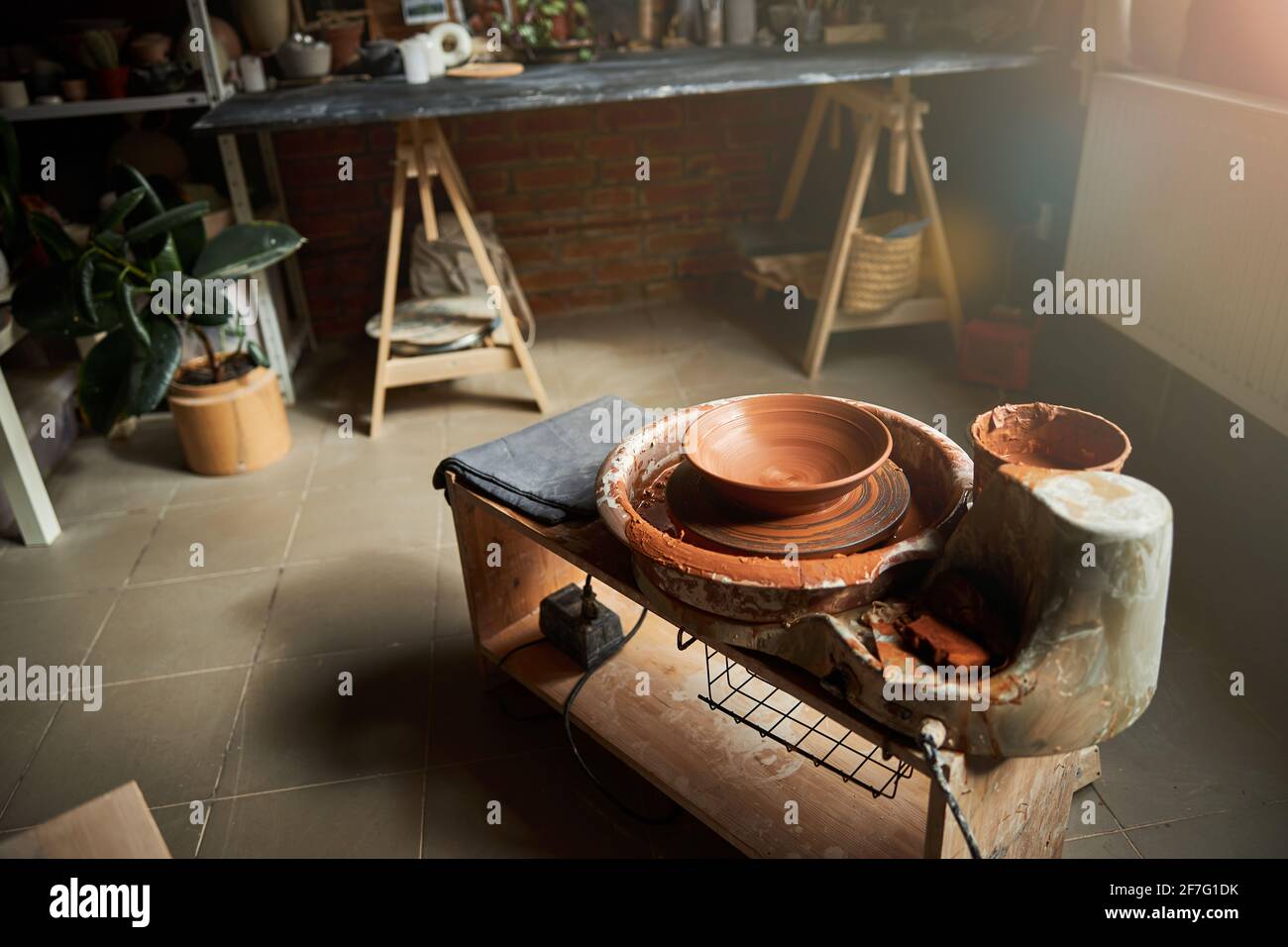 Workplace of ceramic artist with pottery wheel in workshop Stock Photo ...