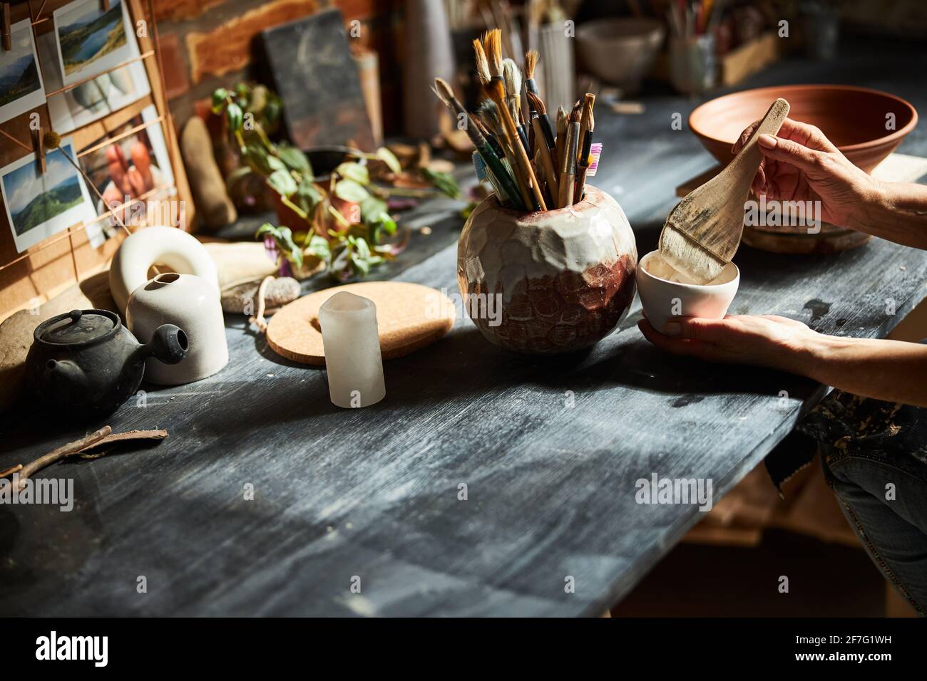 Ceramic artist hands painting pottery in workshop Stock Photo - Alamy