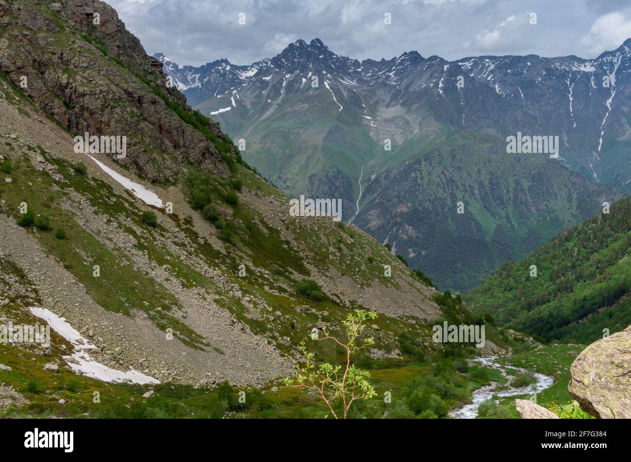 View of the river valley, the mountain range under the clouds and rocky ...