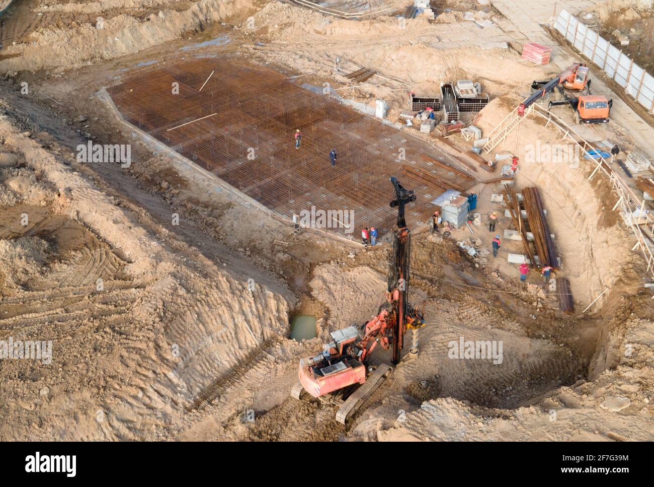 Pile driver at construction site. Piles driven into the ground by ...