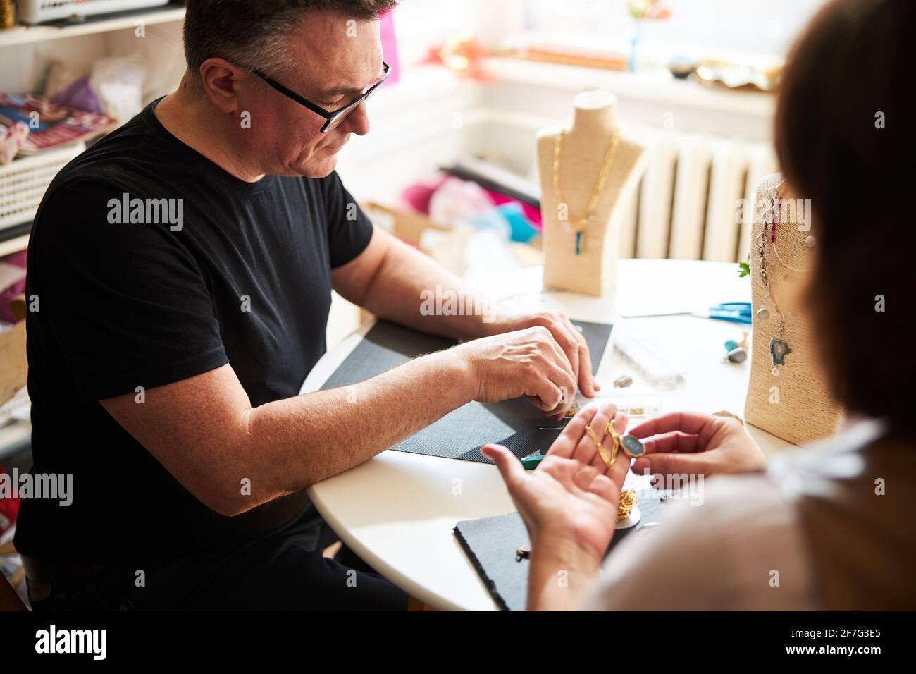 Two jewelers crafting jewelry in the workshop Stock Photo - Alamy