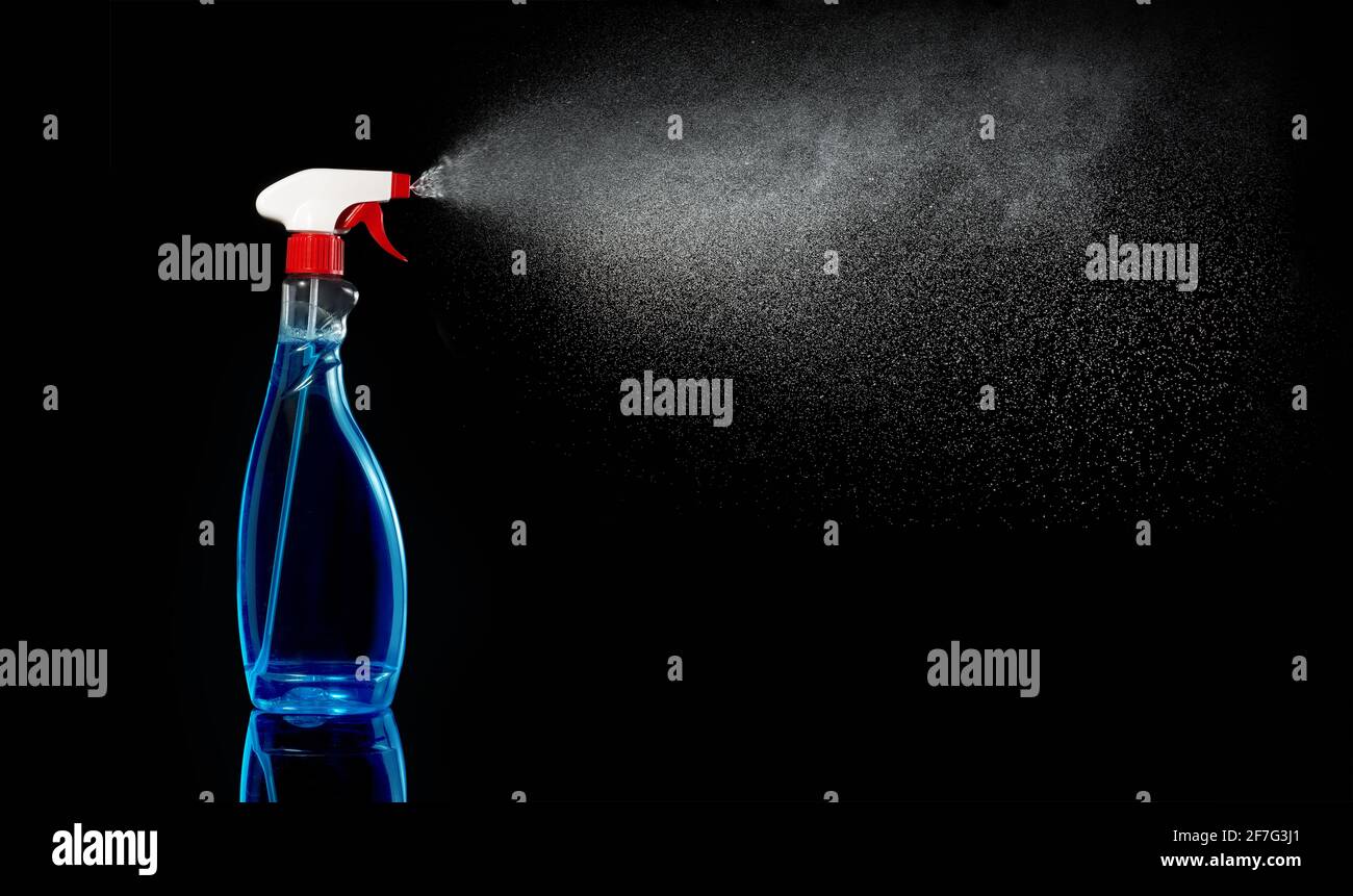 cleanser spraying liquid isolated on black background Stock Photo - Alamy