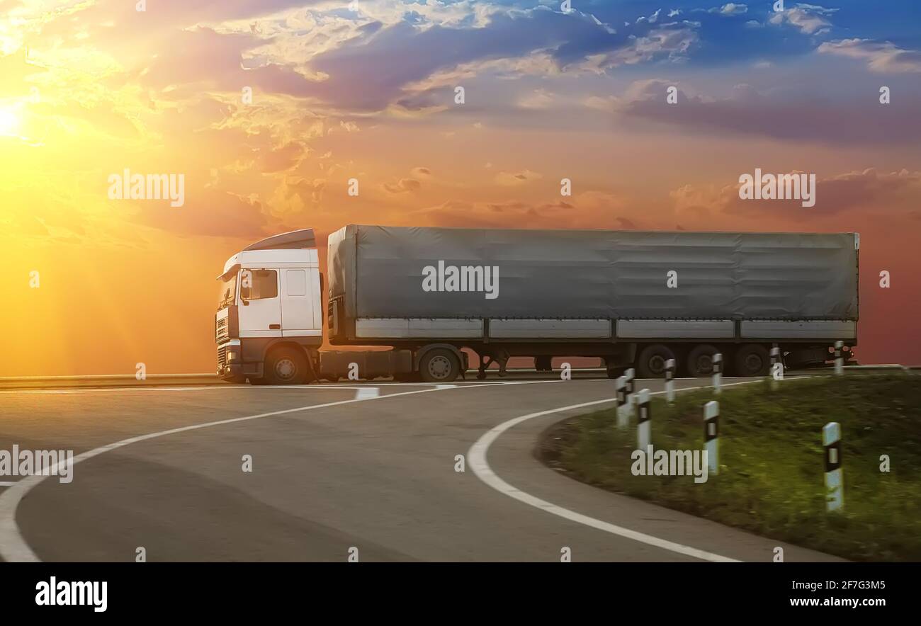 truck goes on highway in evening on sunset Stock Photo - Alamy