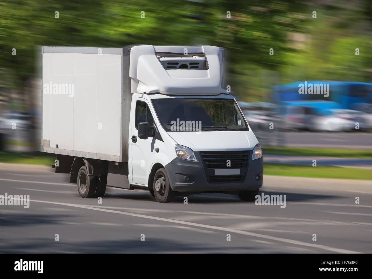 Truck goes on a city street. Cargo delivery Stock Photo - Alamy