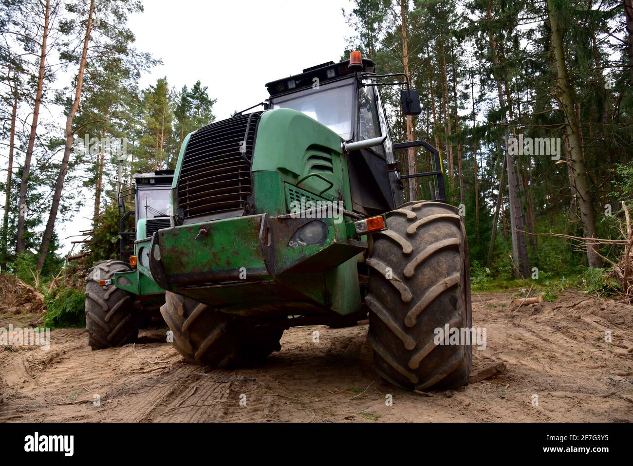 Crane forwarder machines at during clearing of a plantation. Wheeled ...