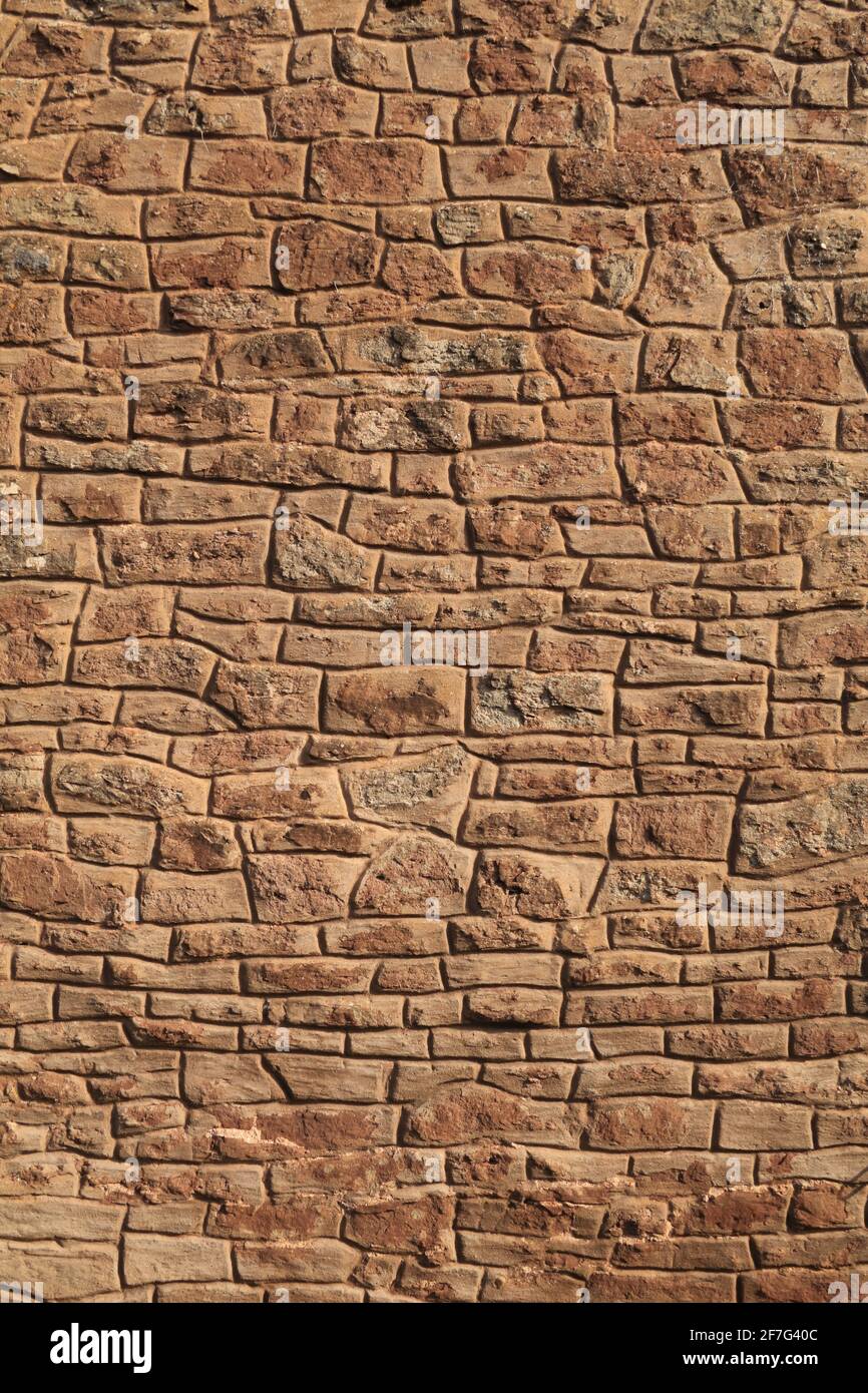 Red sandstone wall in portrait view with shadow highlighting mortar ...