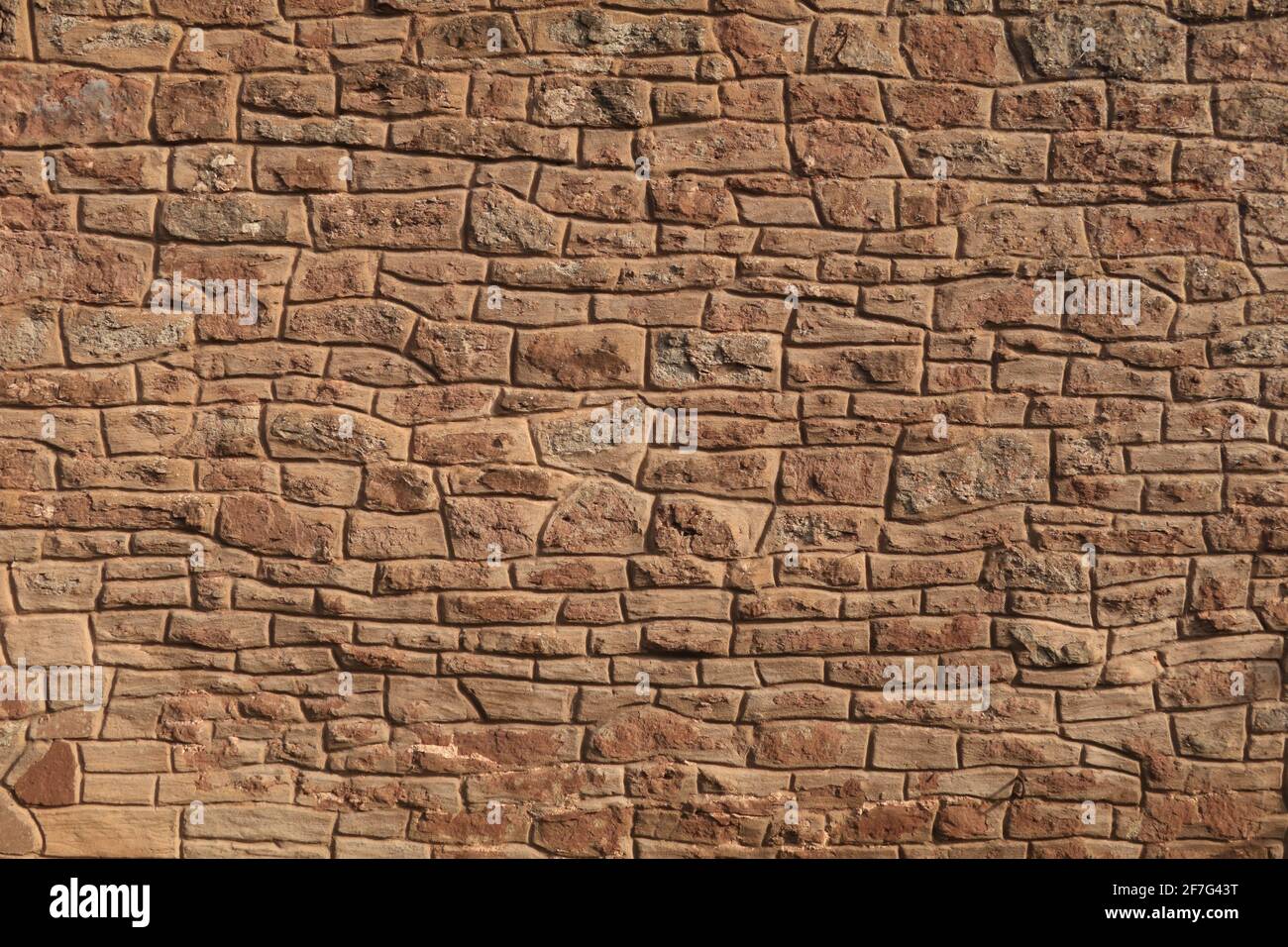 Red sandstone wall in landscape view with shadow highlighting mortar ...