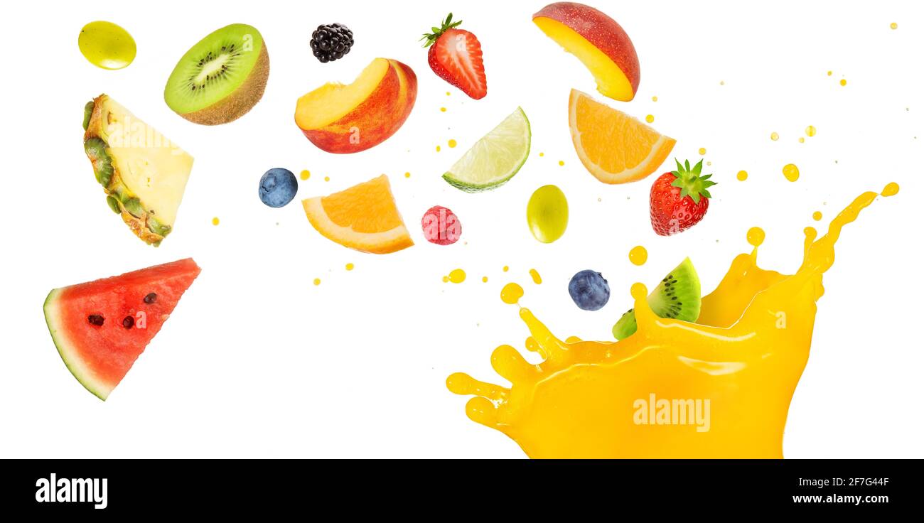 fruit cocktail falling into splashing yellow juice Stock Photo - Alamy