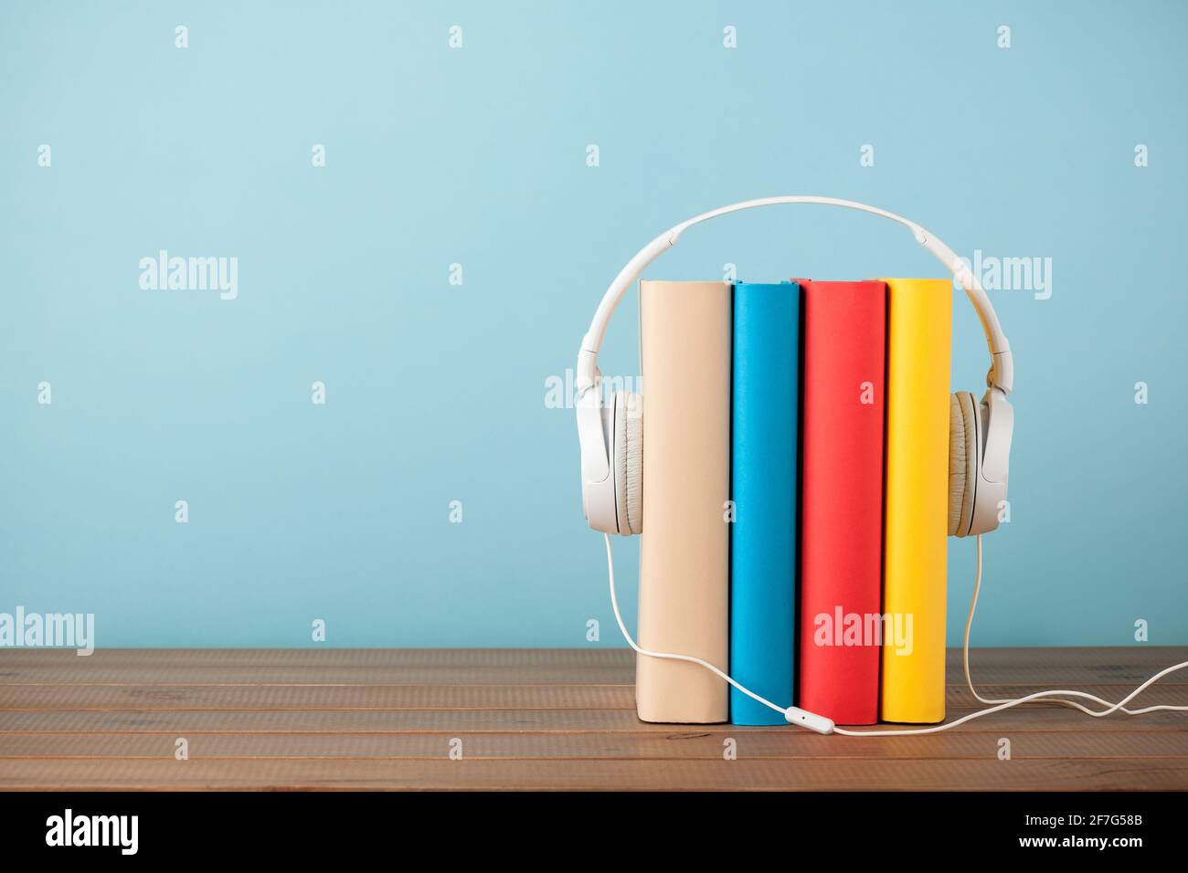 Stack of books with headphones Stock Photo - Alamy