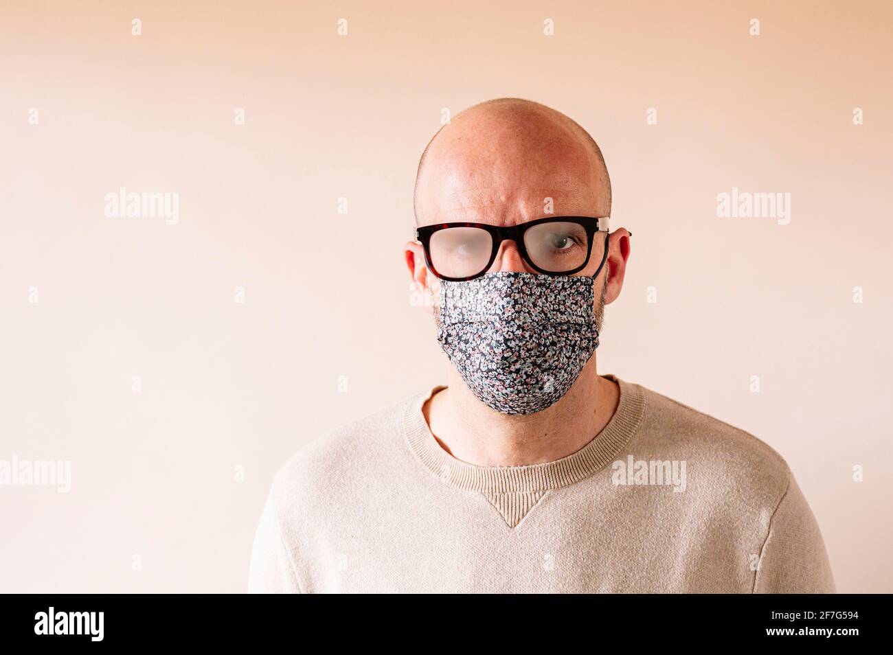 Bald man with flower mask and misted glasses Stock Photo - Alamy