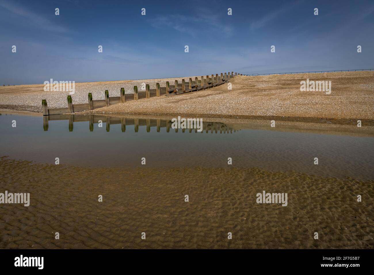 Reflections of groynes on the beach at Camber, East sussex, England ...