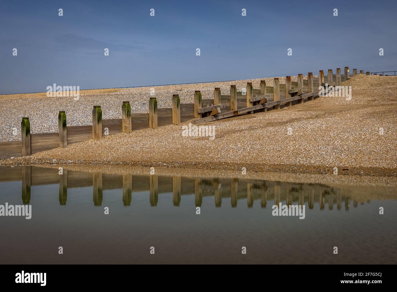Reflections of groynes on the beach at Camber, East sussex, England ...