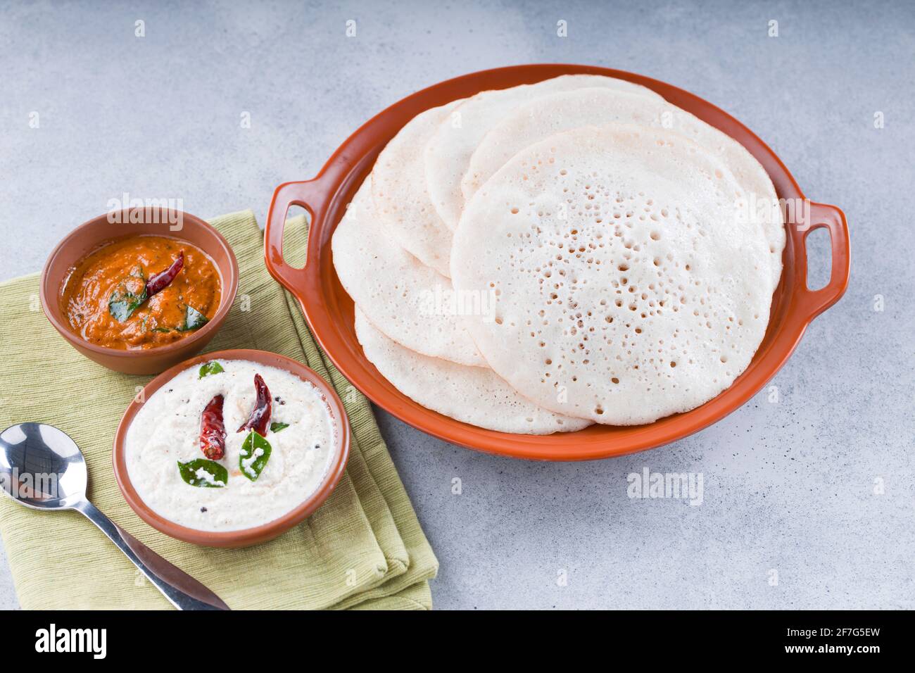 South Indian traditional breakfast Dosa or Thattu dosa made using cast ...