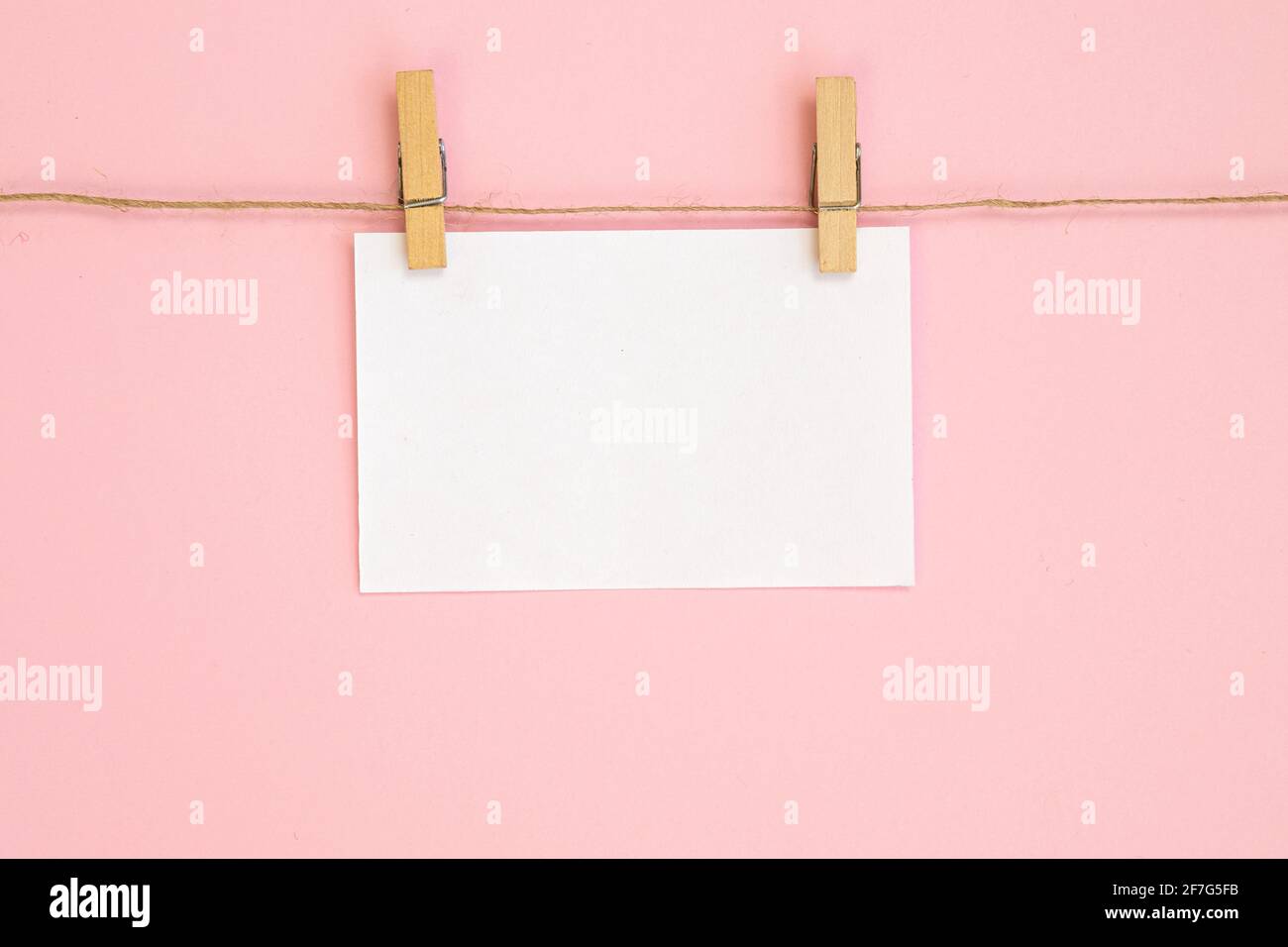 Empty paper sheet for notes, frames that hang on a rope with clothespin ...