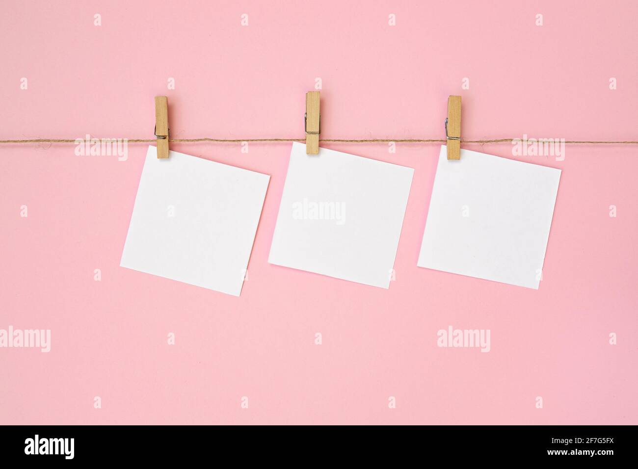 Empty paper sheet for notes, frames that hang on rope with clothespin ...