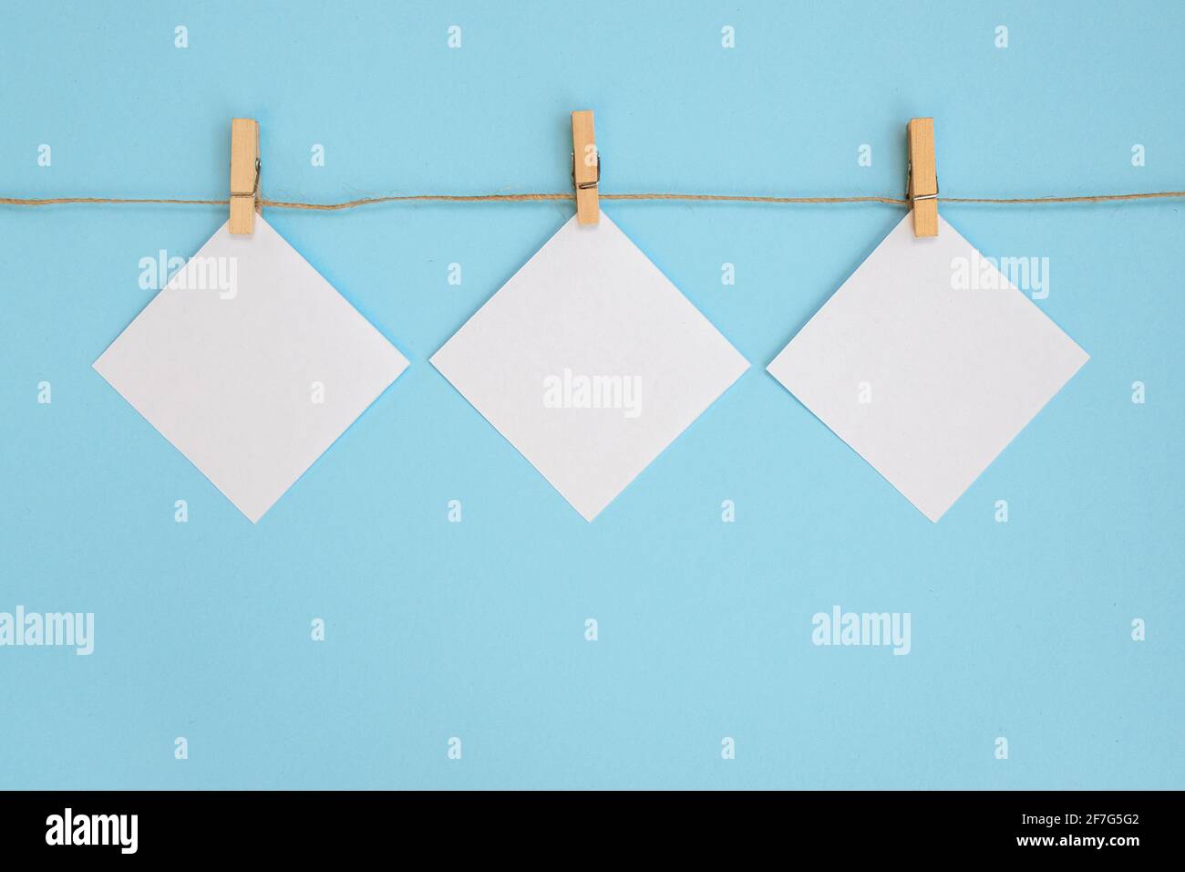 Empty paper sheet for notes, frames that hang on a rope with clothespin ...