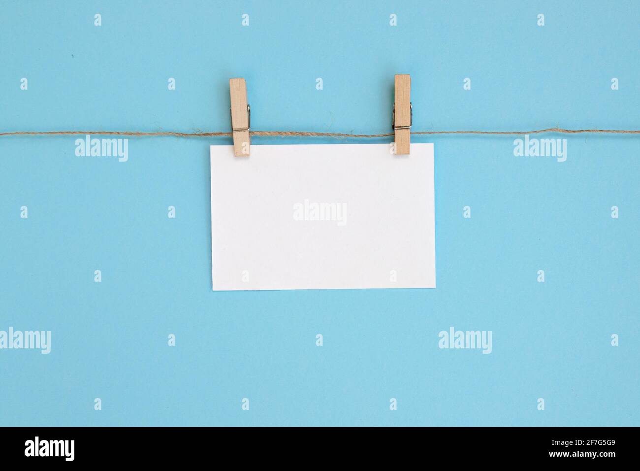 Empty paper sheet for notes, frames that hang on a rope with clothespin ...