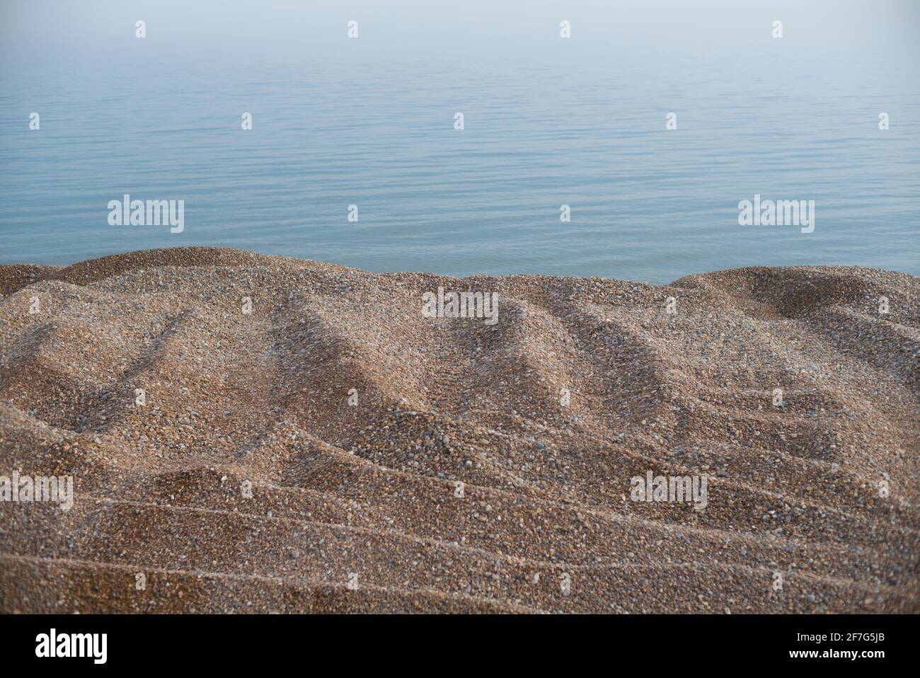 Shingle piled high by the shore Stock Photo - Alamy