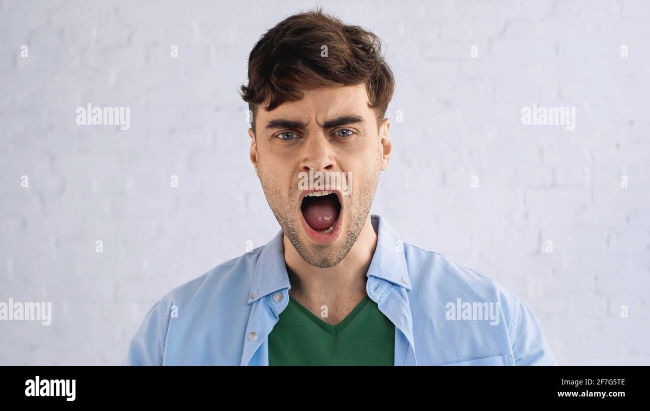 angry man screaming and looking at camera Stock Photo - Alamy