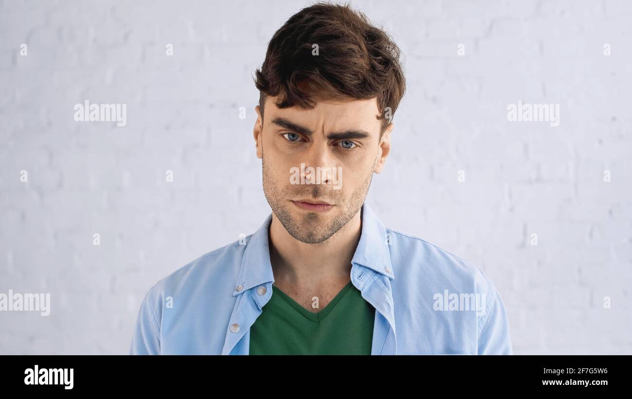 serious man in blue shirt looking at camera Stock Photo - Alamy