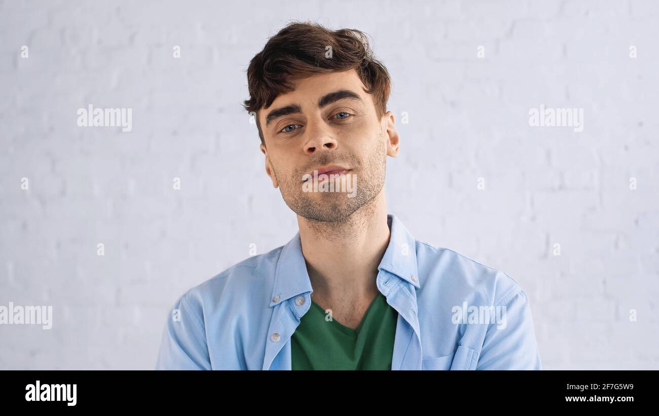 pleased man in blue shirt looking at camera Stock Photo - Alamy