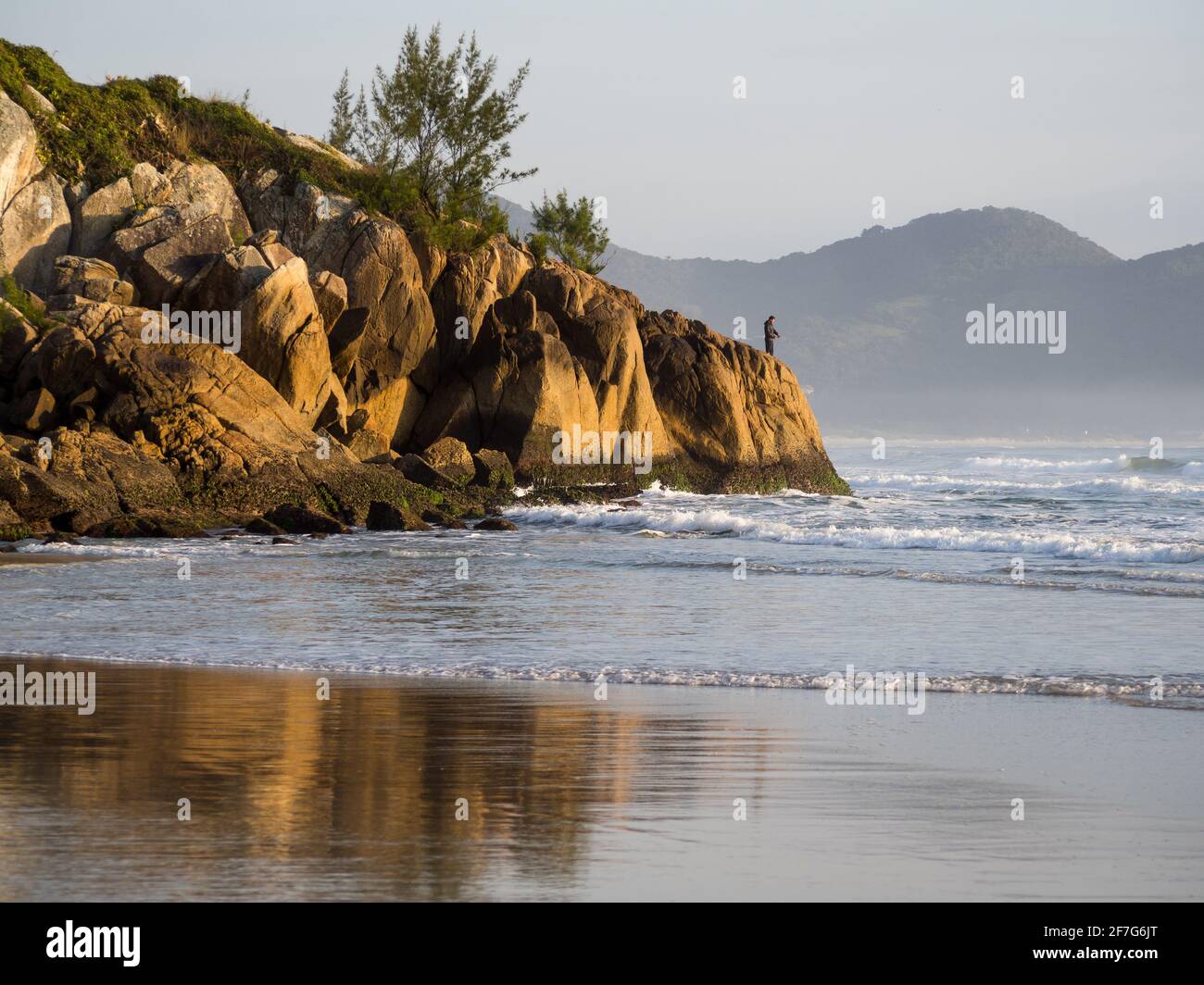 Beach sunrise with some beautiful rocks Stock Photo - Alamy