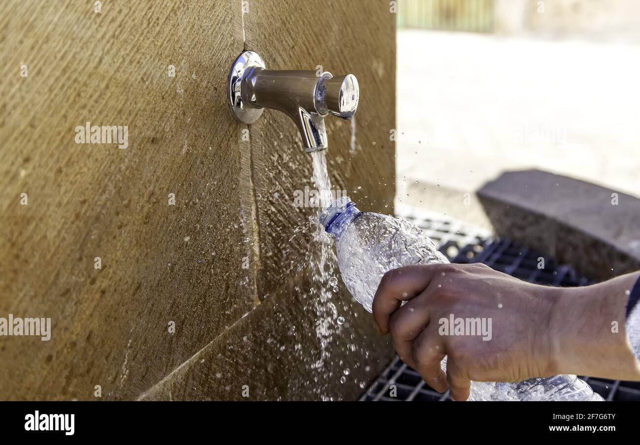 Filling water bottle in fountain, refresh and thirsty Stock Photo - Alamy