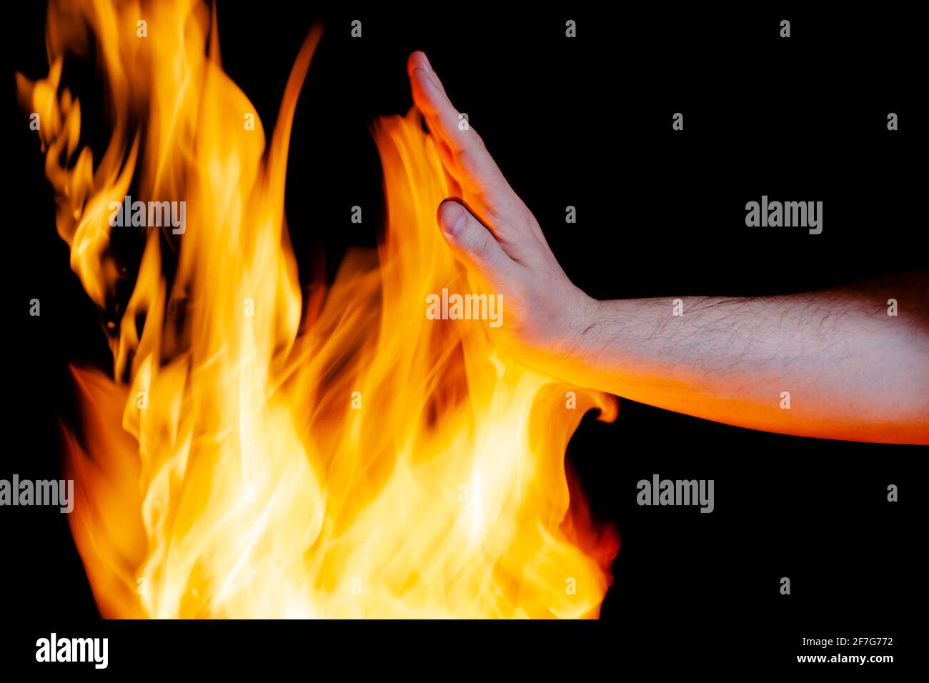mans hand touches the flame, place under the text Stock Photo - Alamy