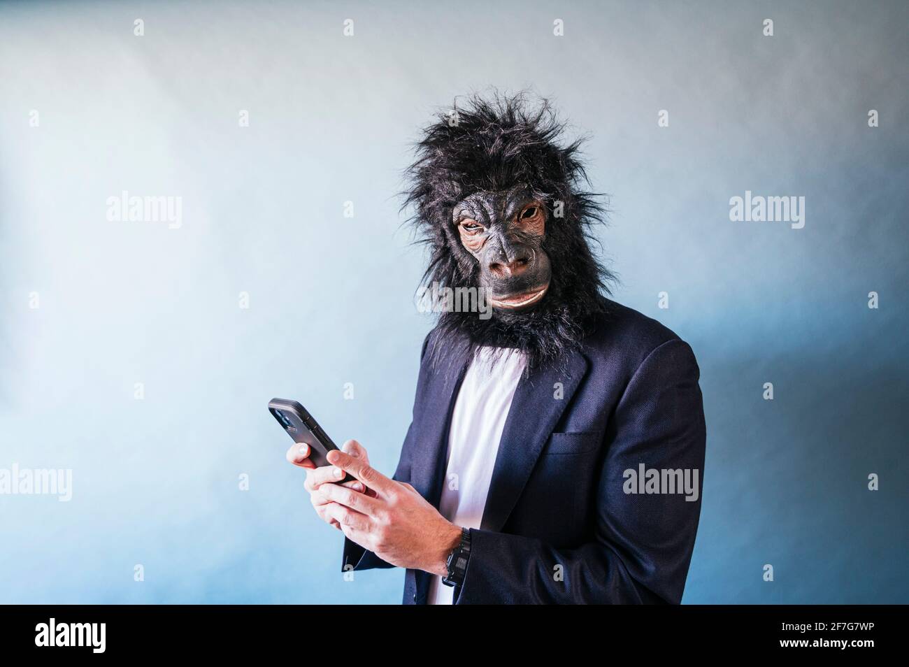 Man with gorilla mask using smart phone Stock Photo - Alamy