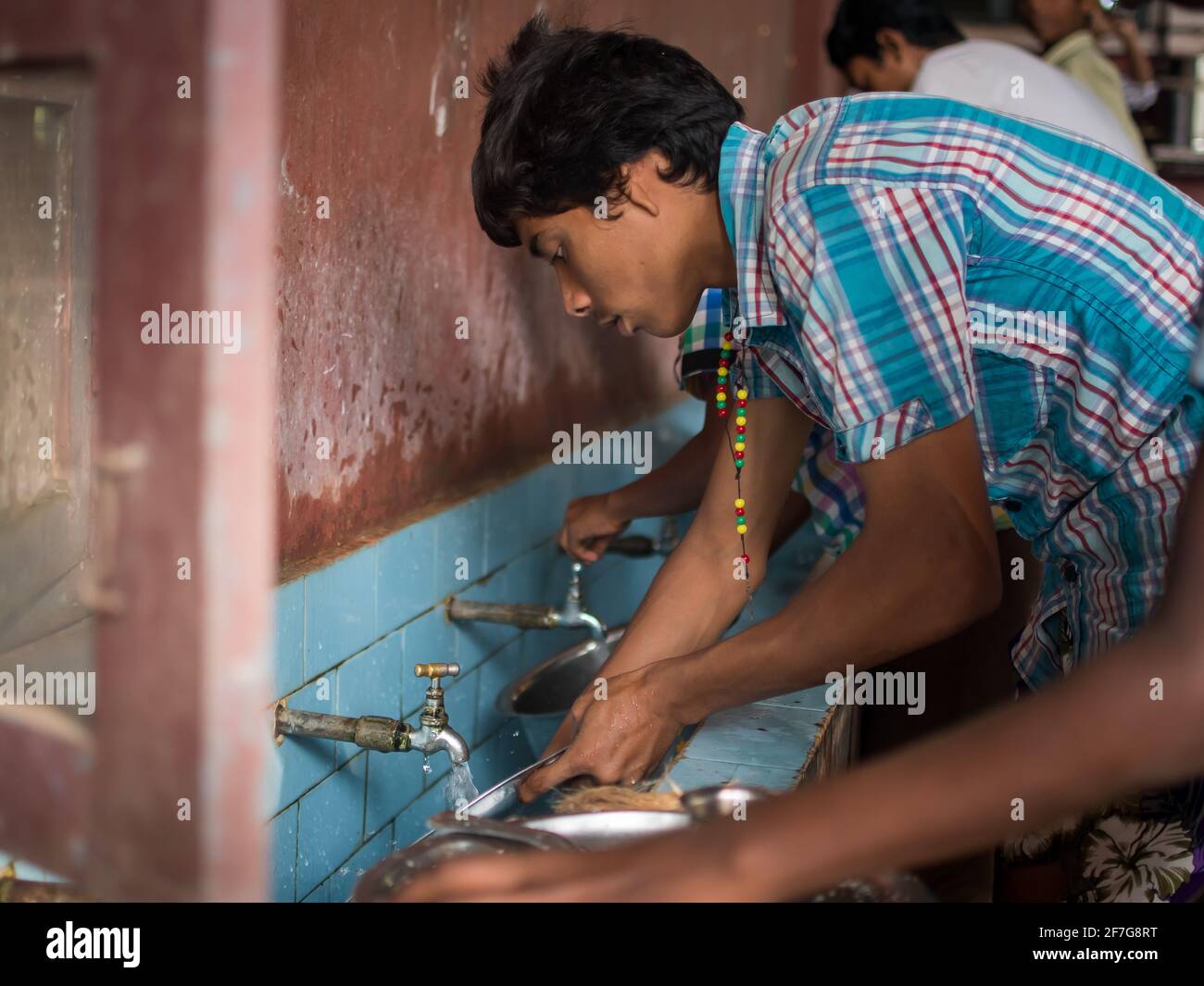 Boy washing plates hi-res stock photography and images - Alamy