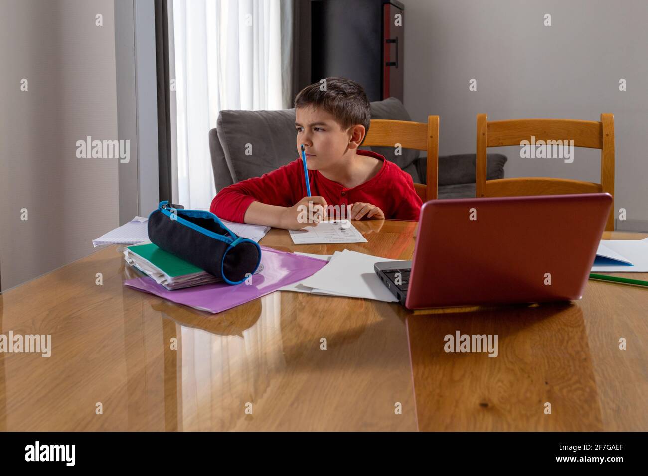 boy doing his homework while lock down, studying remotely Stock Photo ...