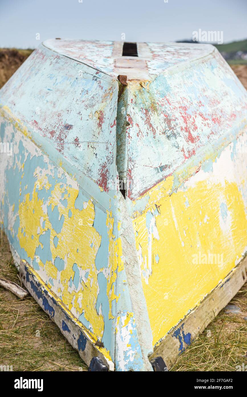 An upturned small boat washed up on the shoreline of a beautiful ...