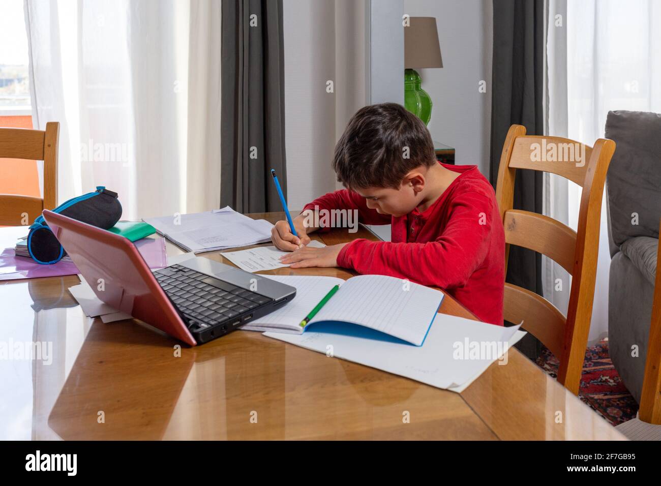 boy doing his homework while lock down, studying remotely Stock Photo ...