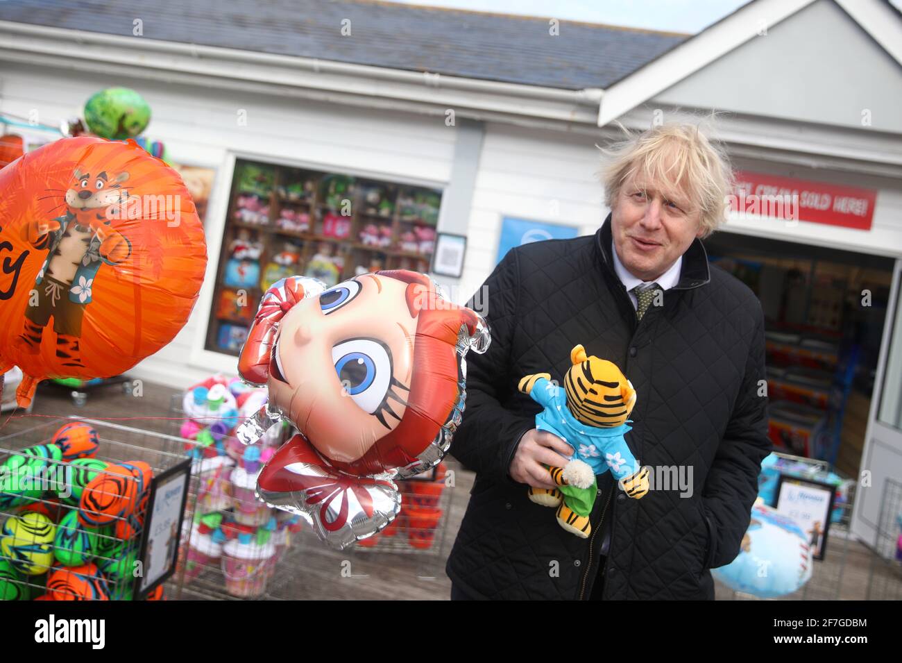 Prime Minister Boris Johnson holding a toy tiger during a visit to ...