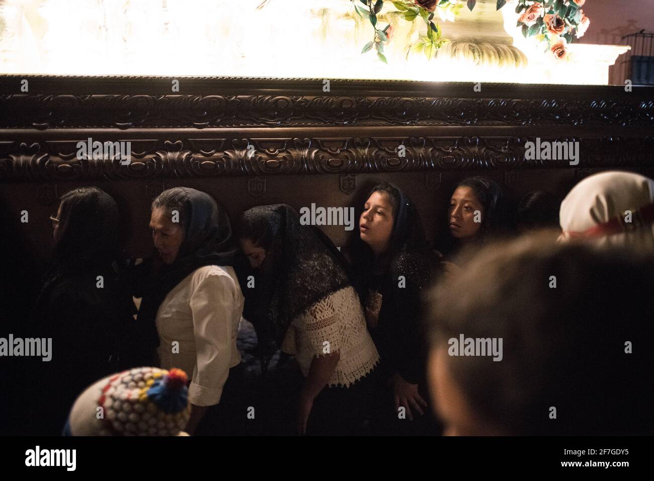 Women carry an elaborate wooden float (anda) during the Semana Santa ...