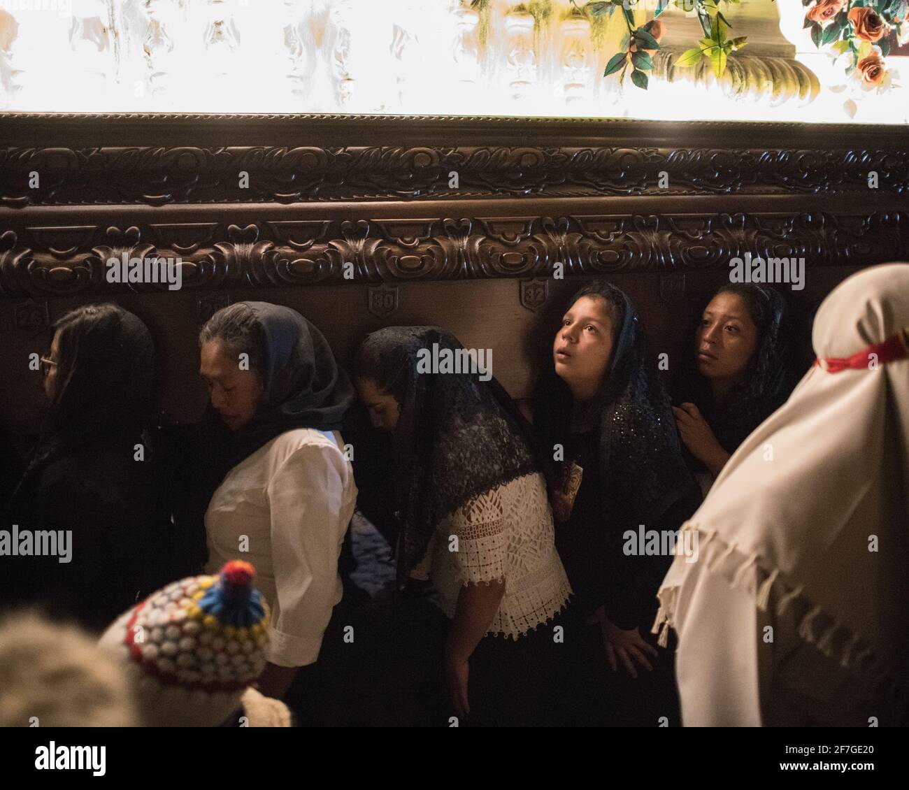 Women carry an elaborate wooden float (anda) during the Semana Santa ...