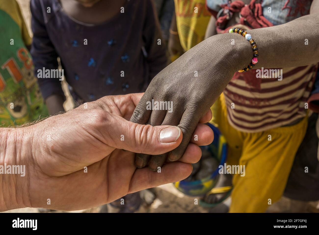 White man holds hands with a little native African Girl, African Peace ...