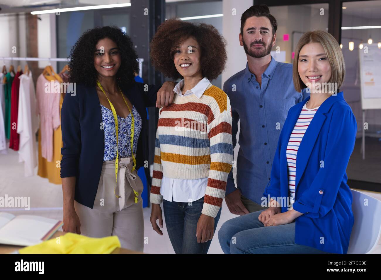 Portrait of creative fashion designer colleagues group looking to ...