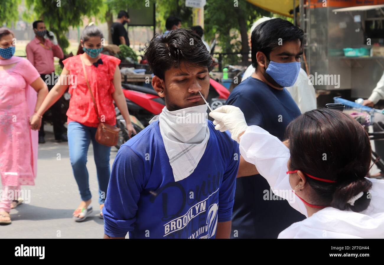 A man getting his sample collected by a health worker during swab ...