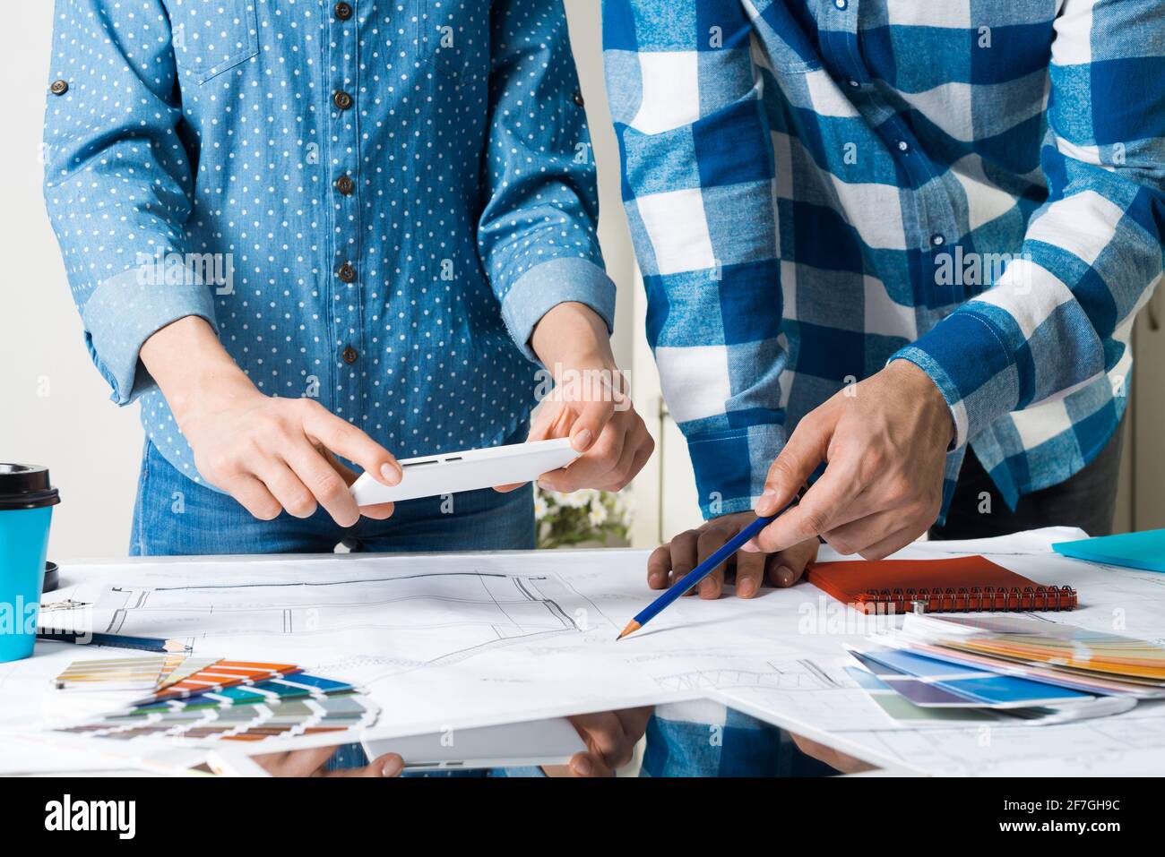Woman taking photo of technical drawing Stock Photo - Alamy