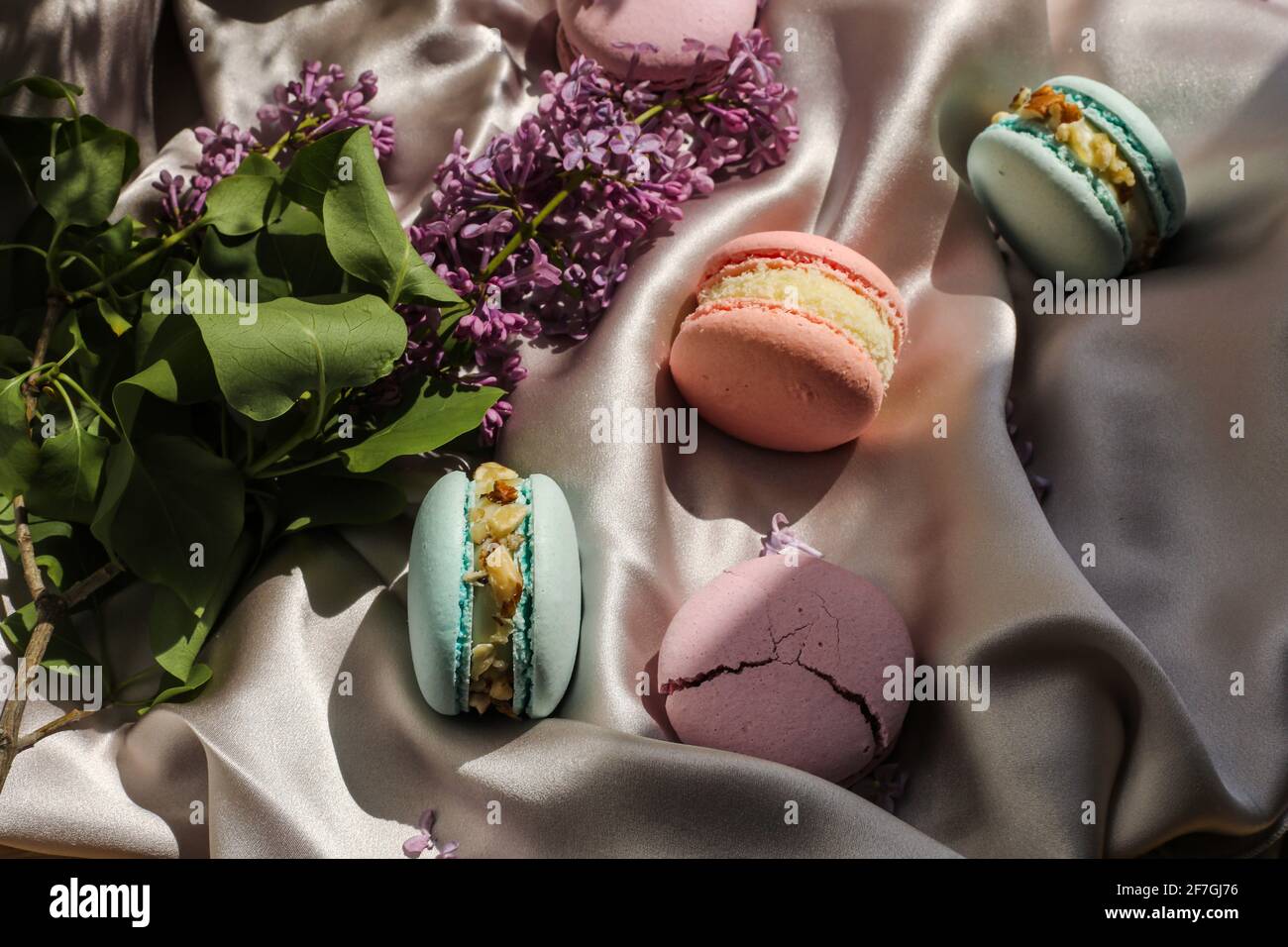 pink and mint french macaroons or macarons cookies and a lilac flowers ...