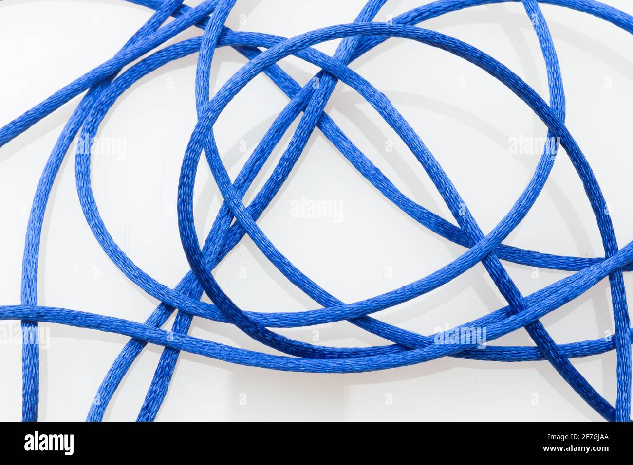 blue messy string, string out of coil a bit messy; blue string on white ...